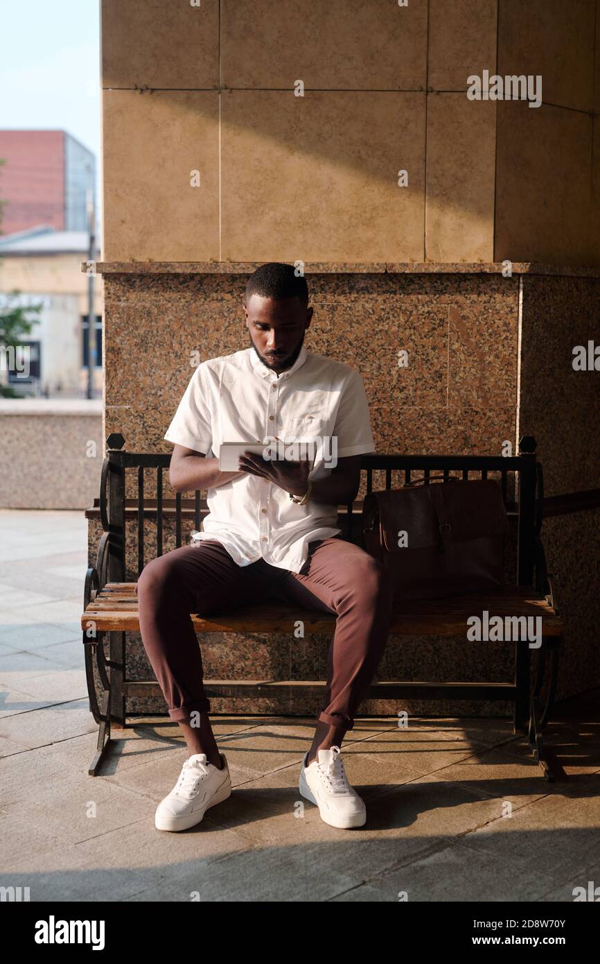 Person sitting on street bench city hi-res stock photography and images ...