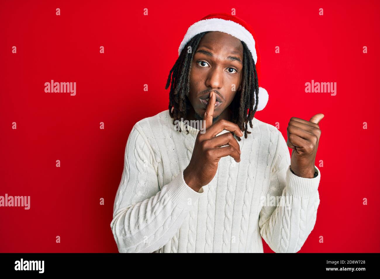 African american man with braids wearing christmas hat asking to be ...