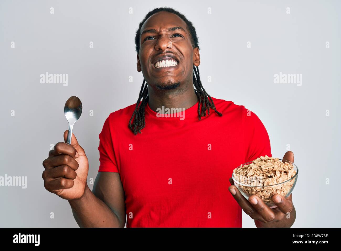 African american man with braids eating healthy whole grain celears ...