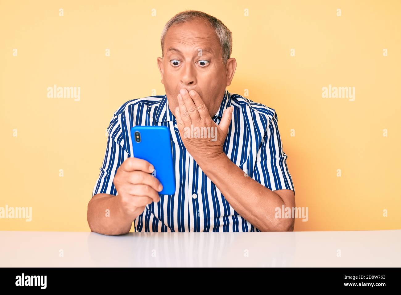 Senior Handsome Man With Gray Hair Using Smartphone Sitting On The