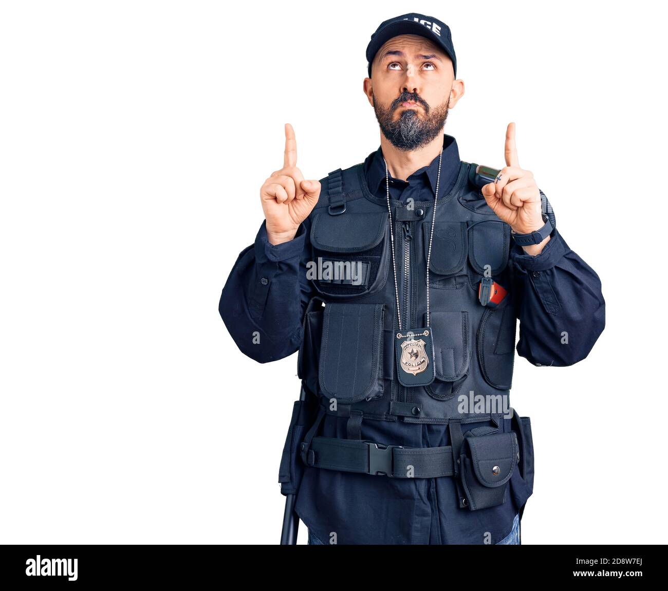 Young handsome man wearing police uniform pointing up looking sad and ...