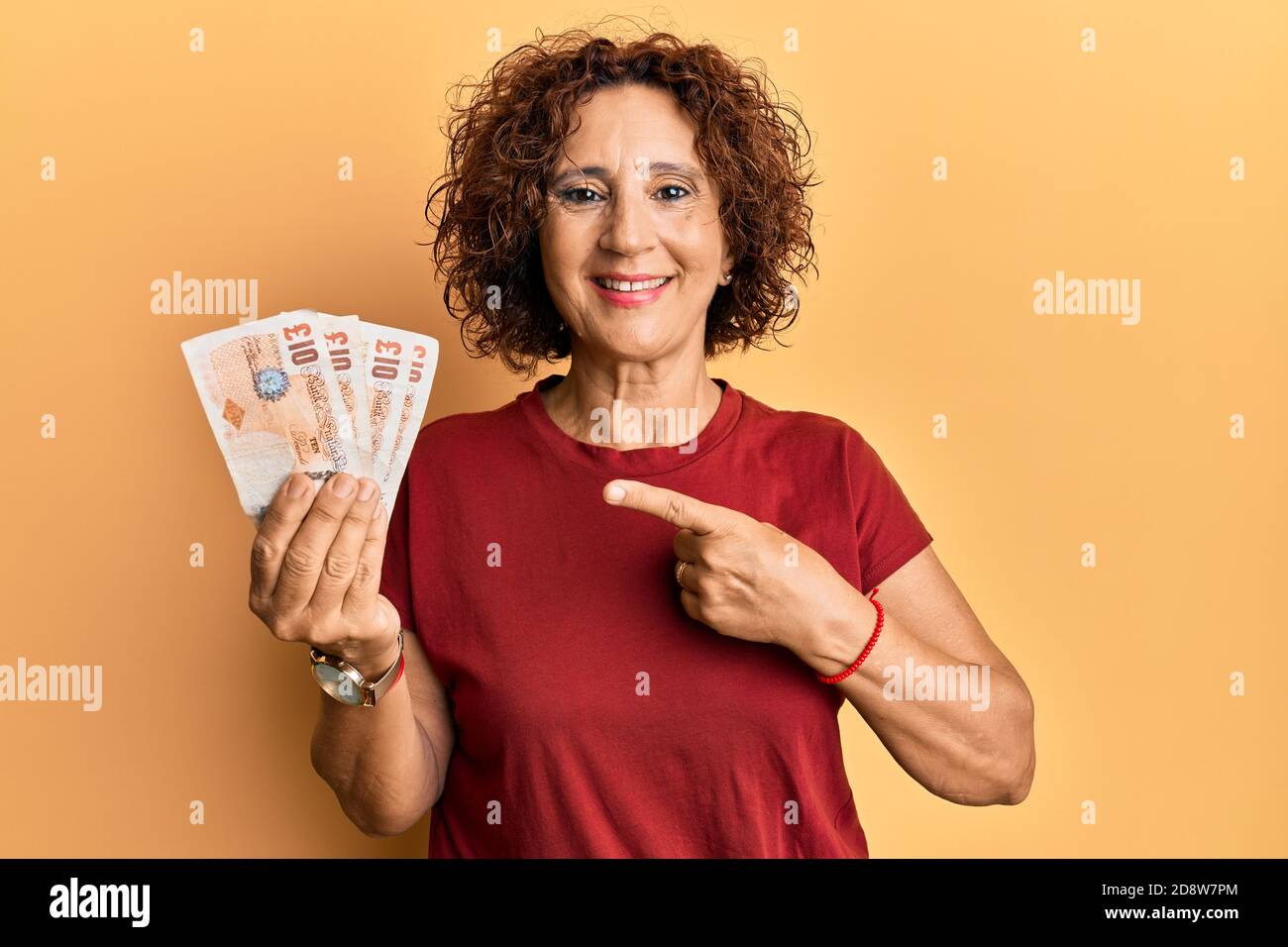 Mature woman smiling money pound hi-res stock photography and images ...