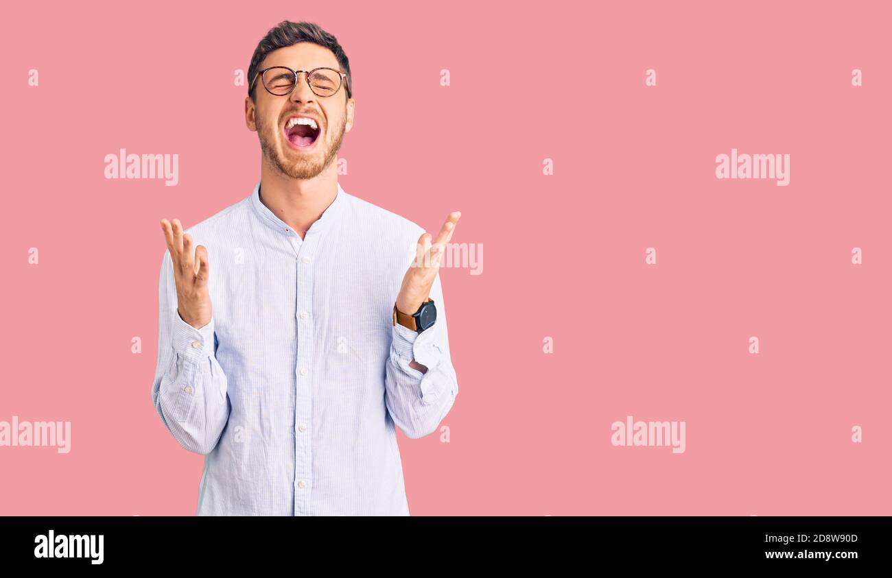 Handsome young man with bear wearing elegant business shirt and glasses ...