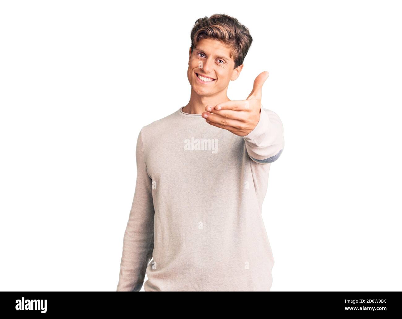 Young handsome man wearing casual clothes smiling friendly offering ...