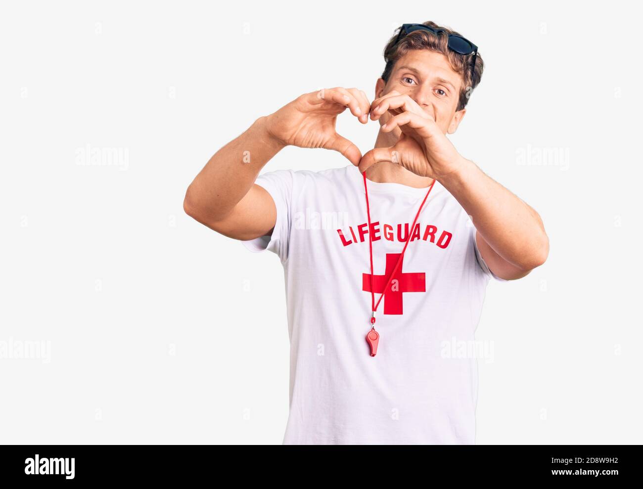Young handsome man wearing lifeguard t shirt and whistle smiling in ...