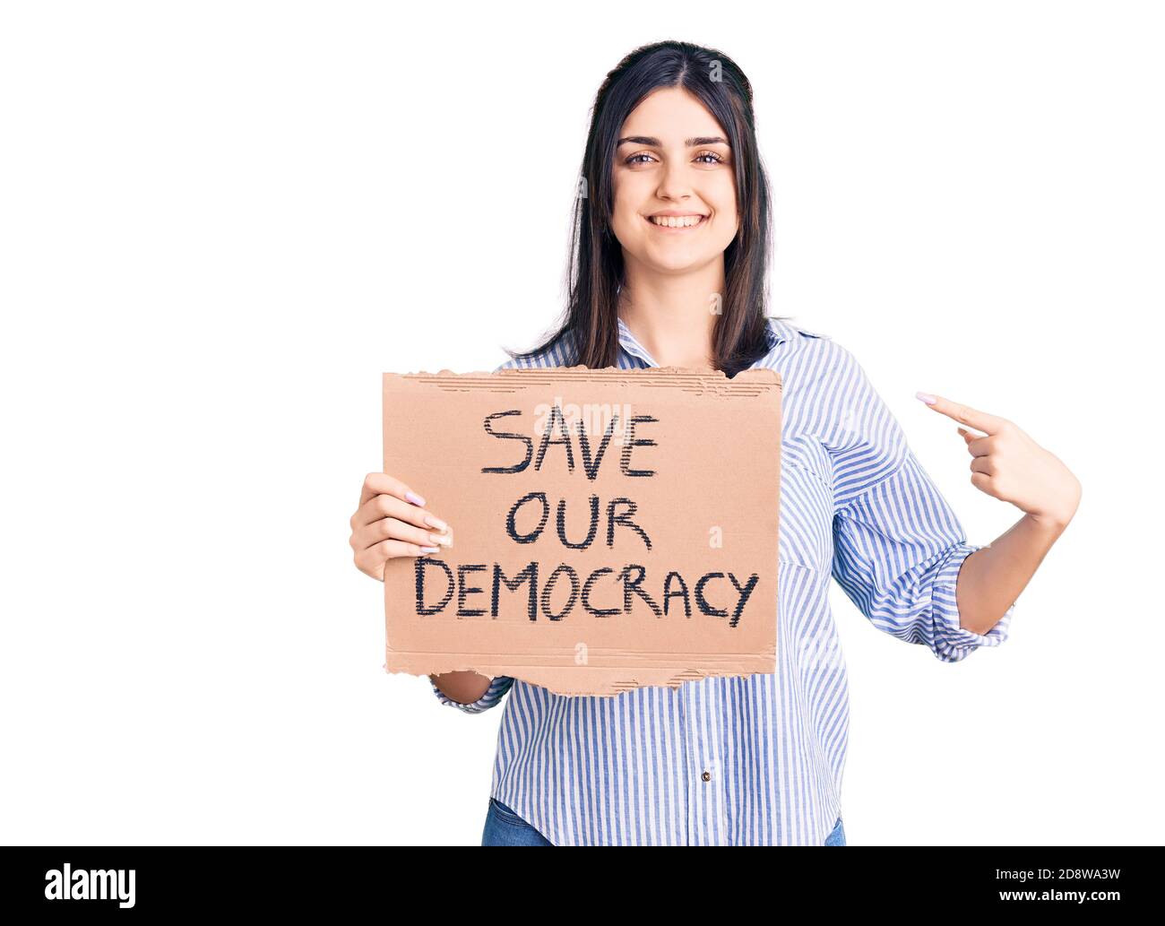 Young beautiful girl holding save our democracy cardboard banner ...