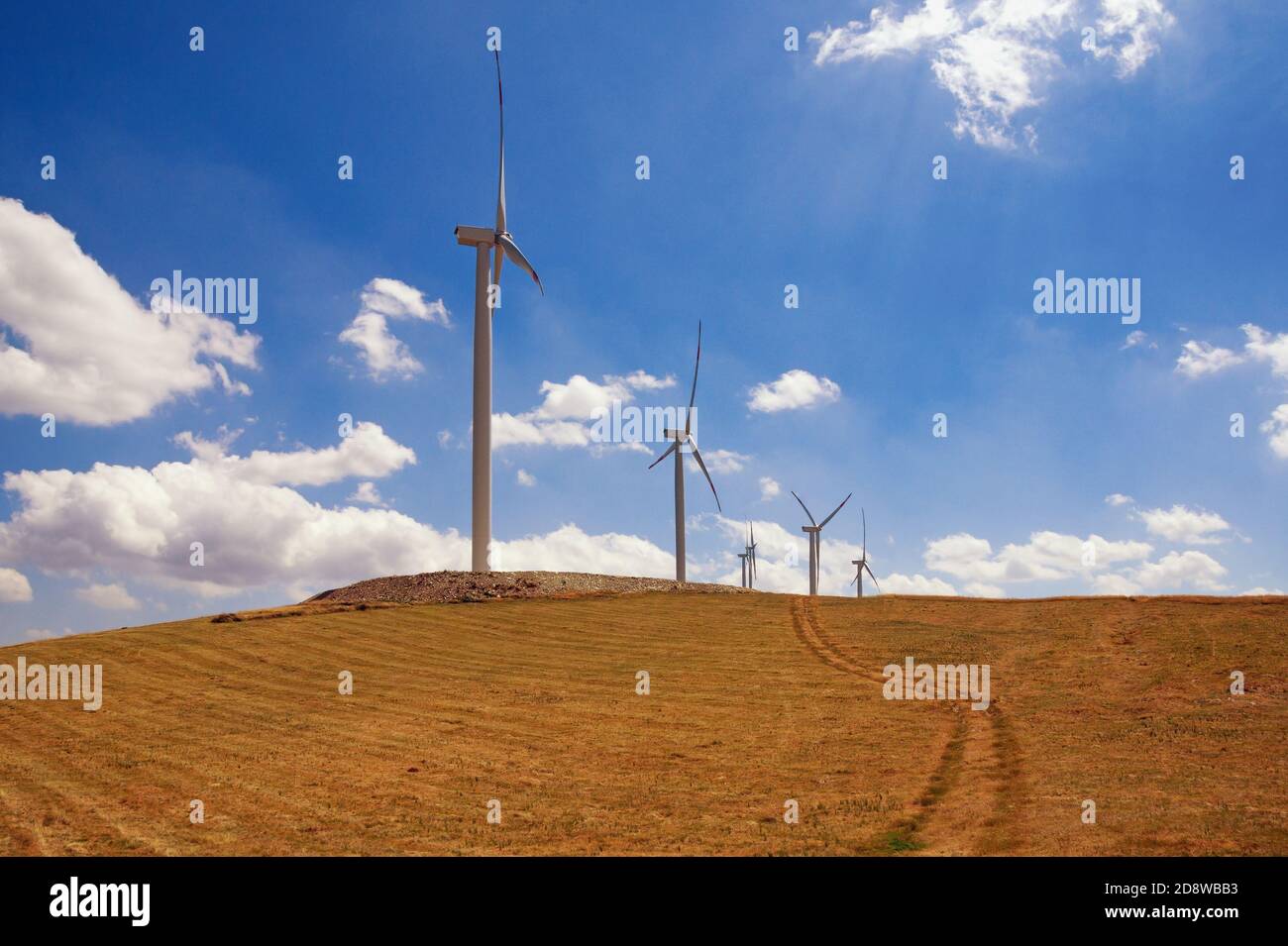 Windmills on a hill against a blue sky with white clouds. Montenegro ...