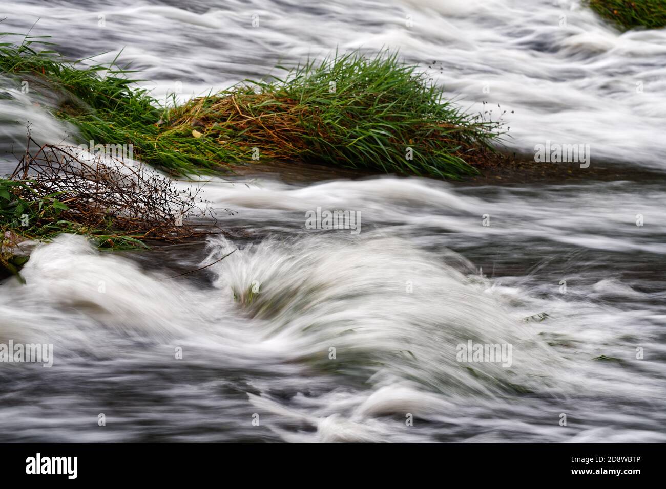 Detail view of flowing water of a small river, flowing structures, long ...
