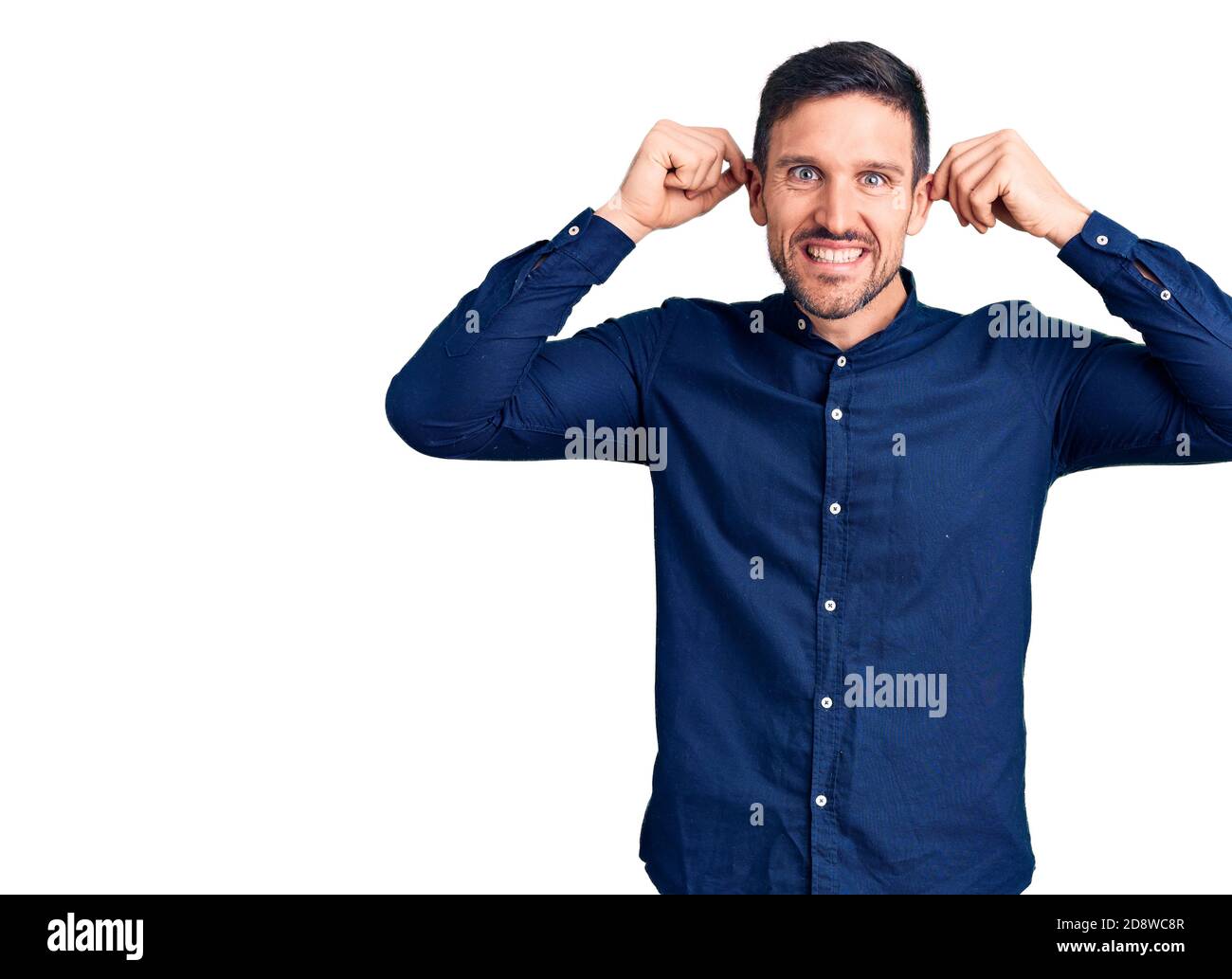 Young handsome man wearing casual shirt smiling pulling ears with ...