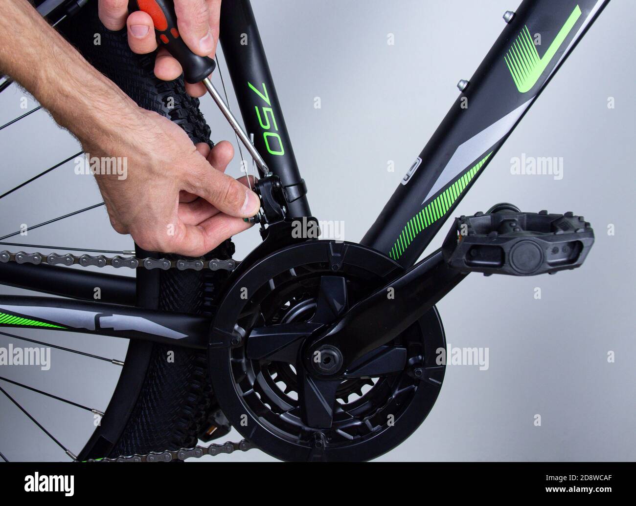 Adjusting and repairing a bike with a tool. Bicycle repair concept ...