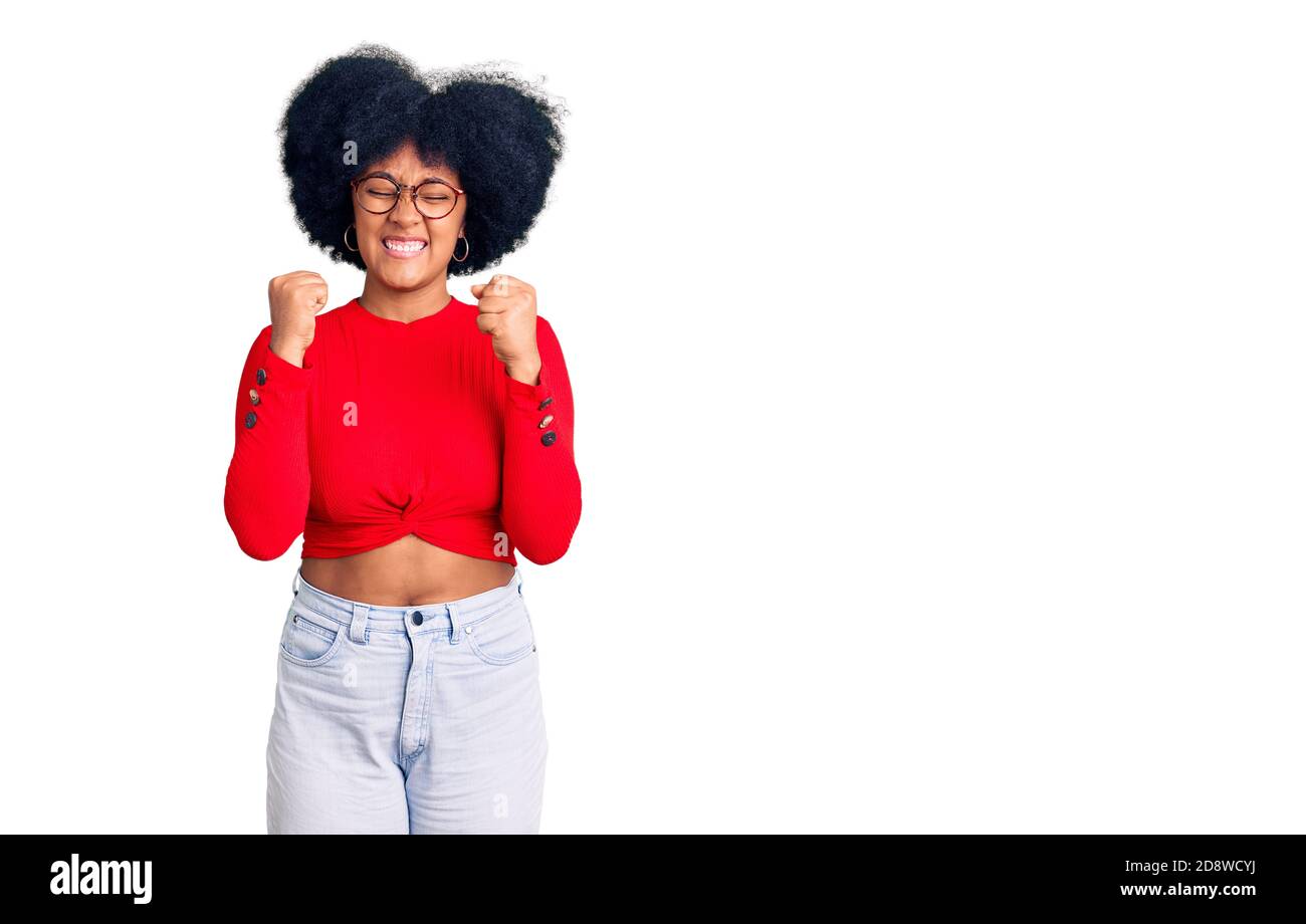 Young african american girl wearing casual clothes and glasses excited ...