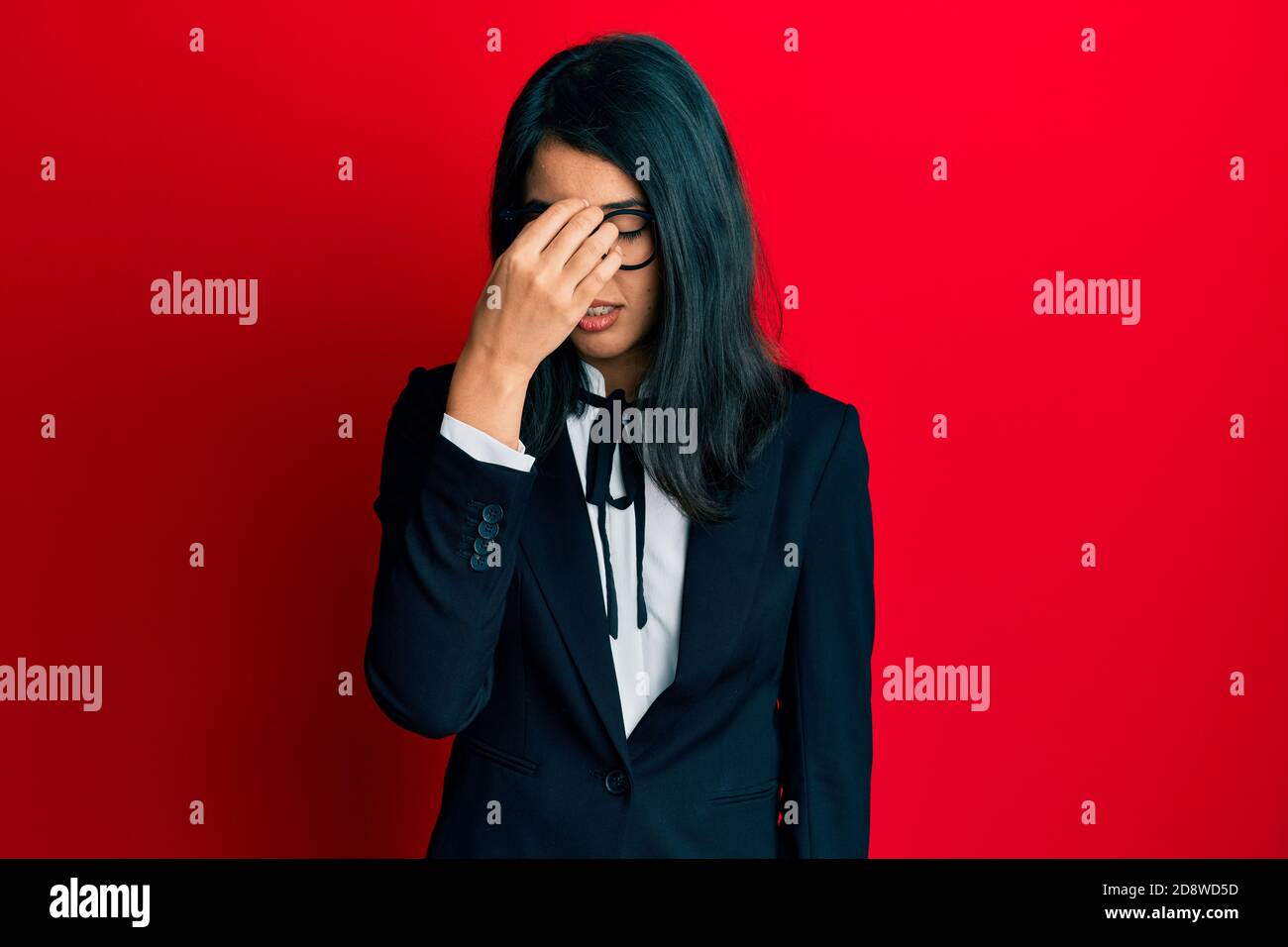 Beautiful asian young woman wearing business suit tired rubbing nose ...