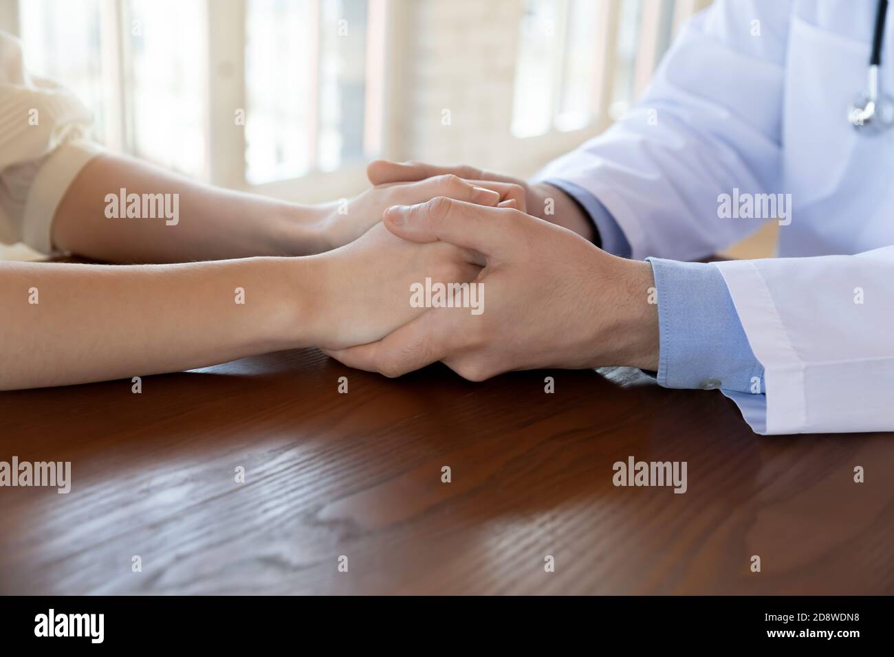 Doctor holding patient hands with care encouraging to take treatment ...