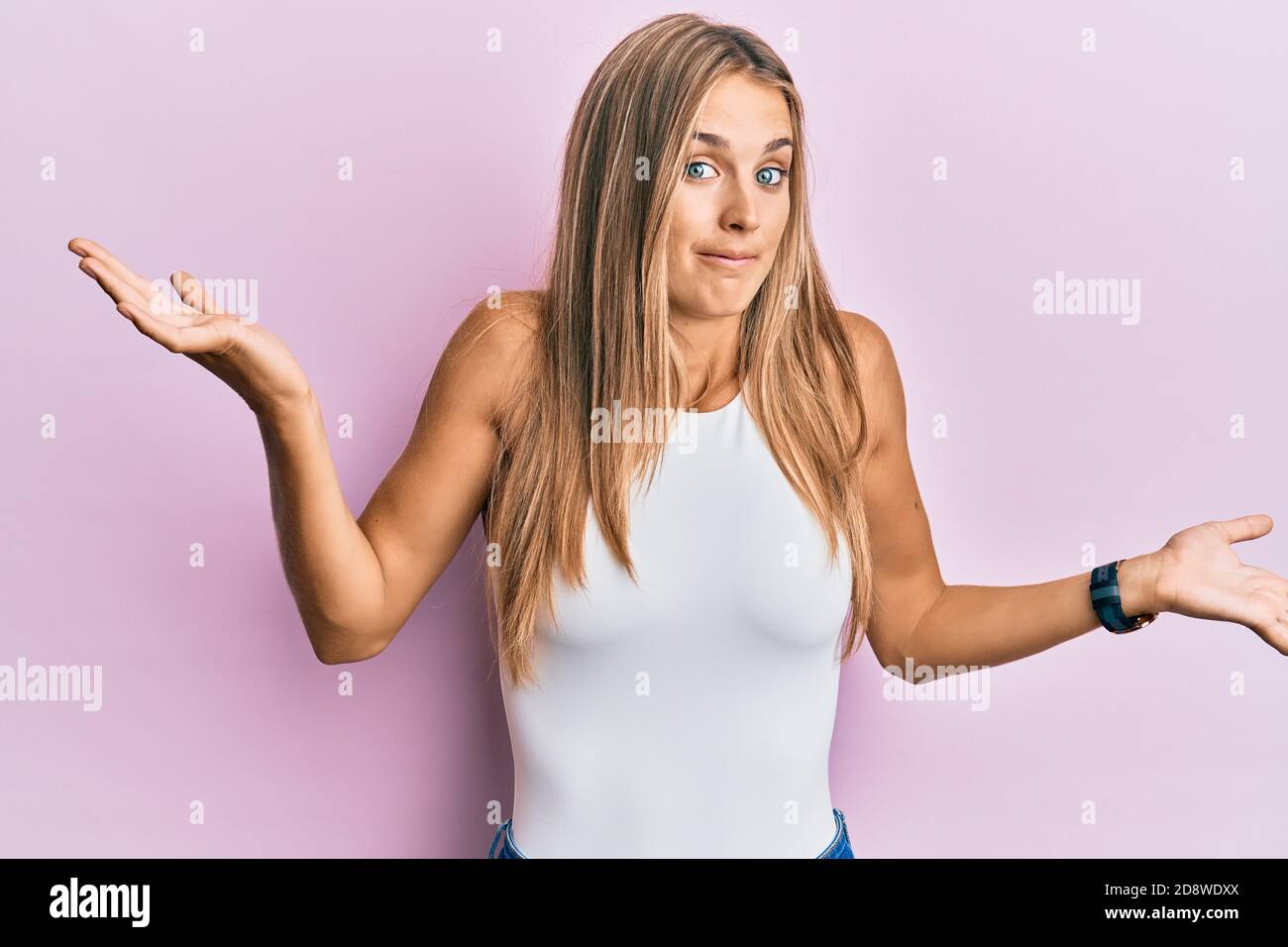 Young blonde woman wearing casual clothes clueless and confused with ...