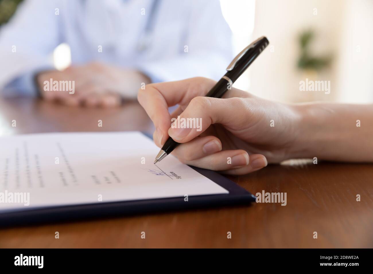 Young female hand holding pen able to sign paper contract Stock Photo ...