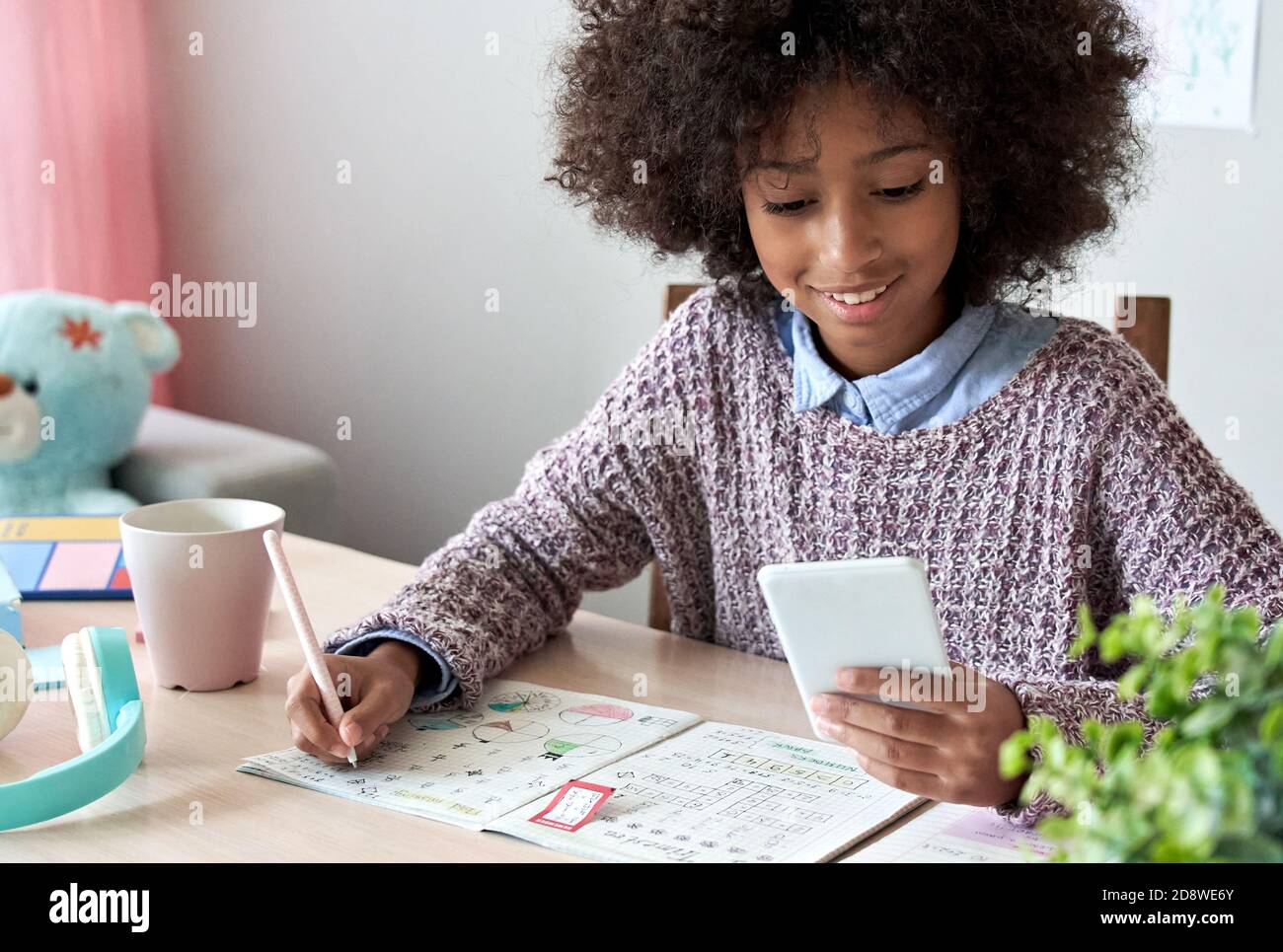 African kid school girl using mobile phone app distance learning class ...