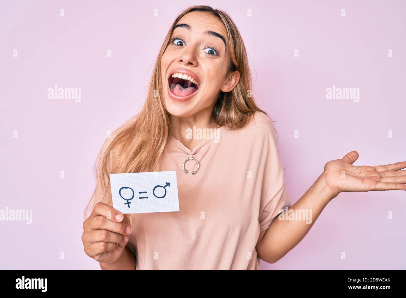 Young beautiful blonde woman holding we are equal paper celebrating ...