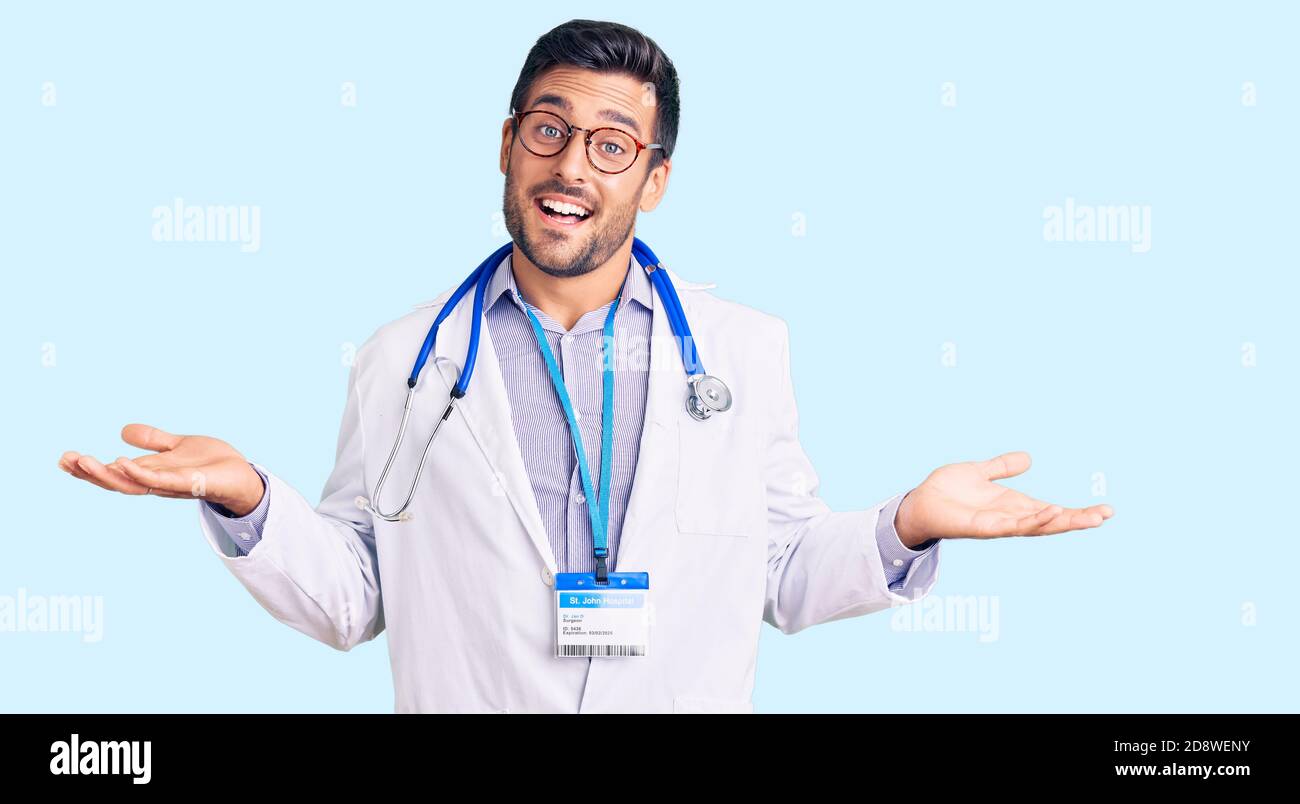 Young hispanic man wearing doctor uniform and stethoscope smiling ...
