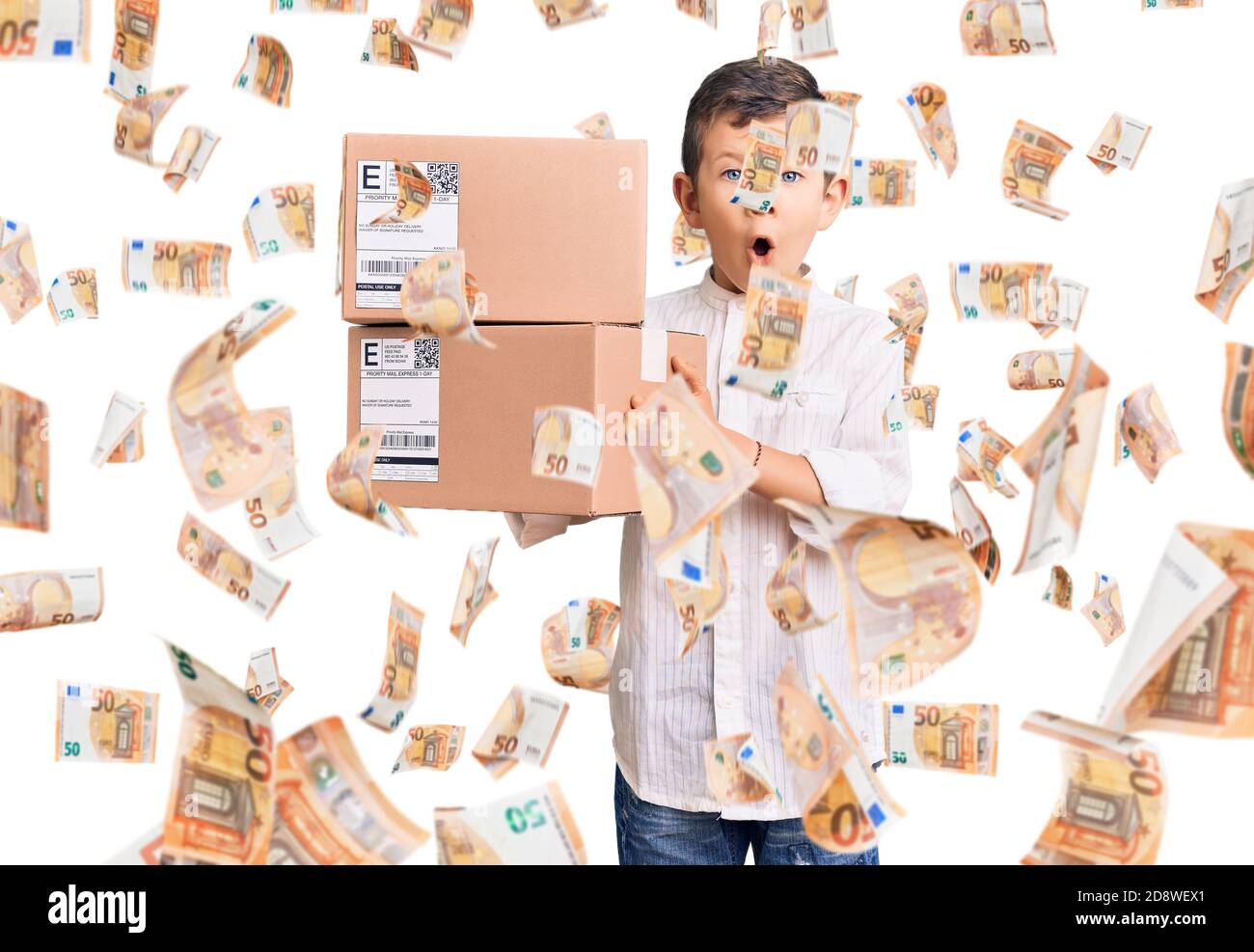 Cute blond kid holding delivery package scared and amazed with open ...