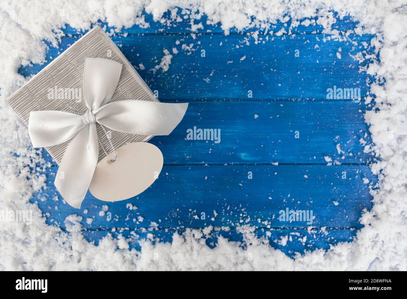 Christmas background with gift box and blank card on blue wooden table ...