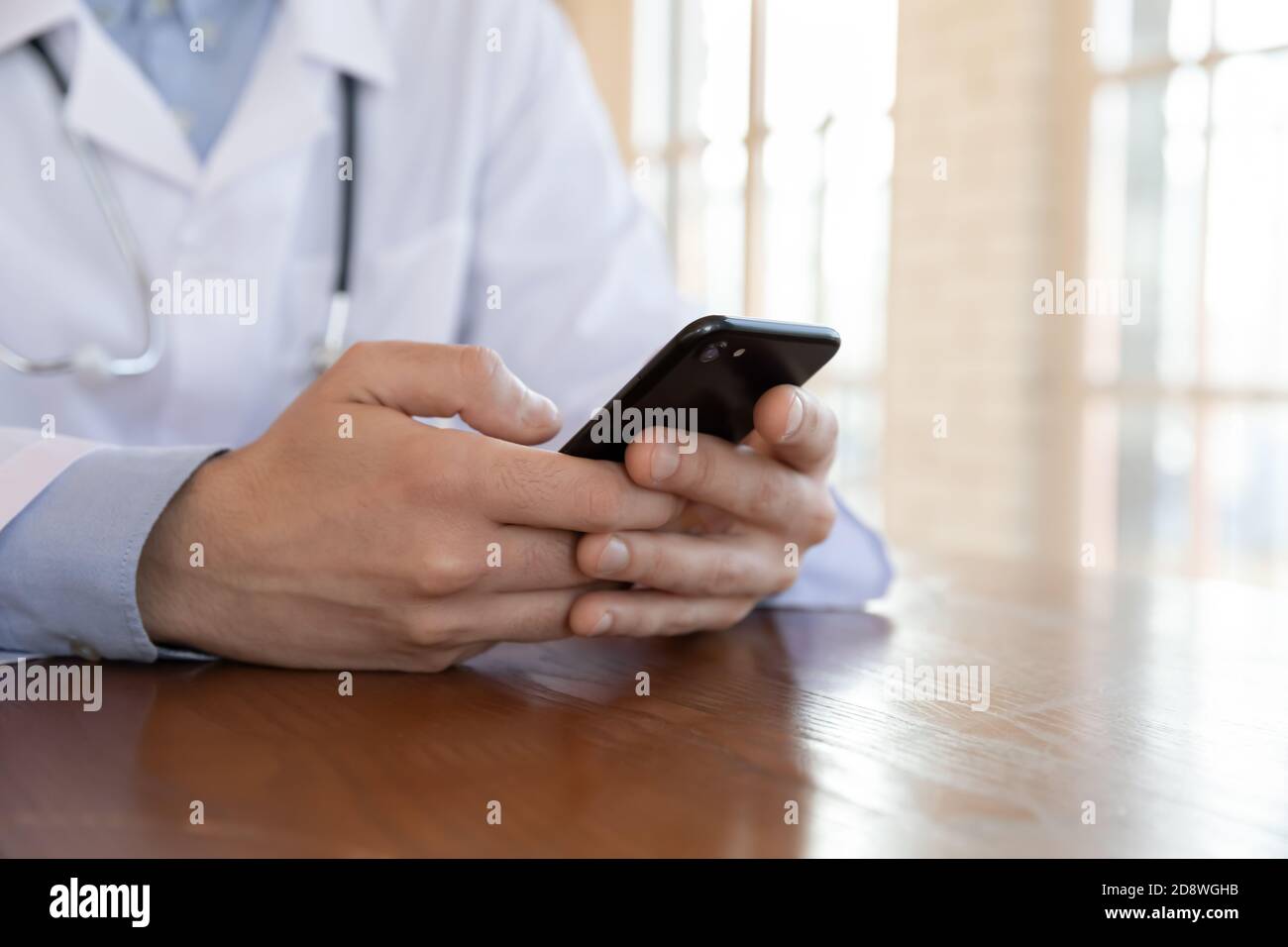 Closeup of male doctor making call to patient by cellphone Stock Photo ...