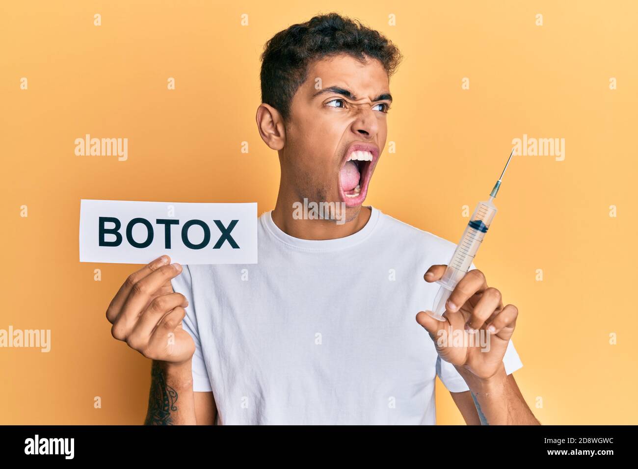Young handsome african american man holding botox banner and needle ...