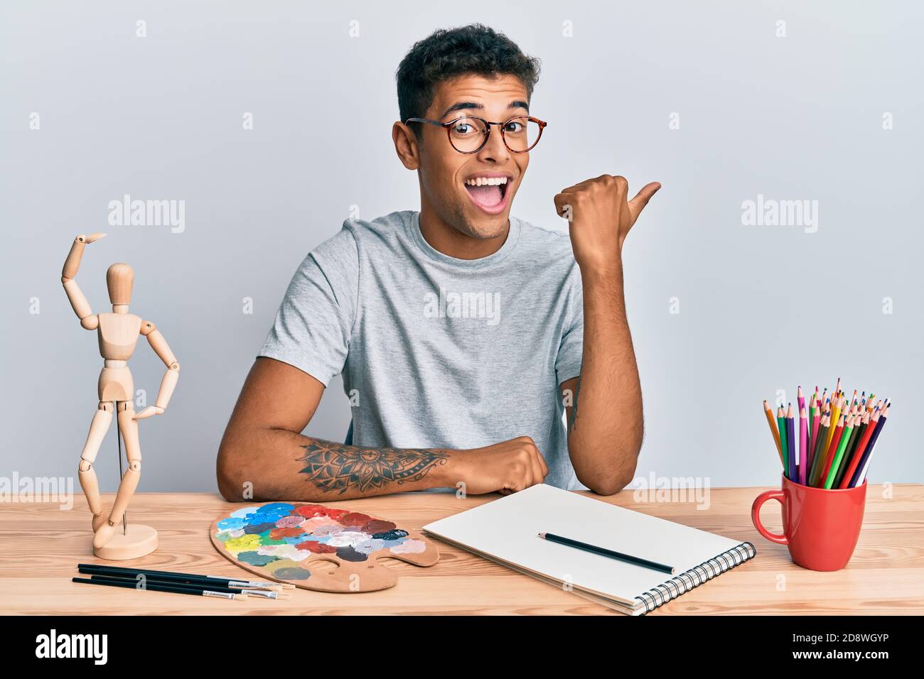 Young handsome african american man painter sitting palette and art ...