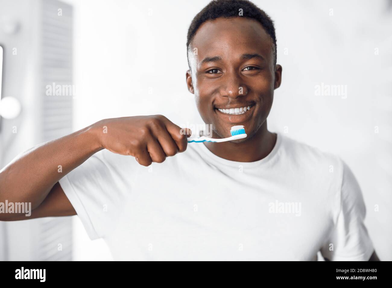 Happy African American Man Cleaning Teeth Standing In Bathroom Stock ...