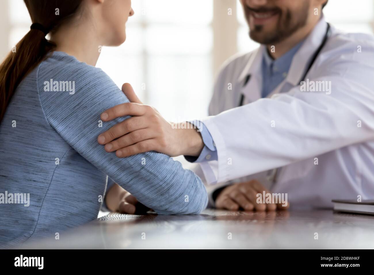 Smiling optimistic doctor greeting patient with complete recovery Stock ...