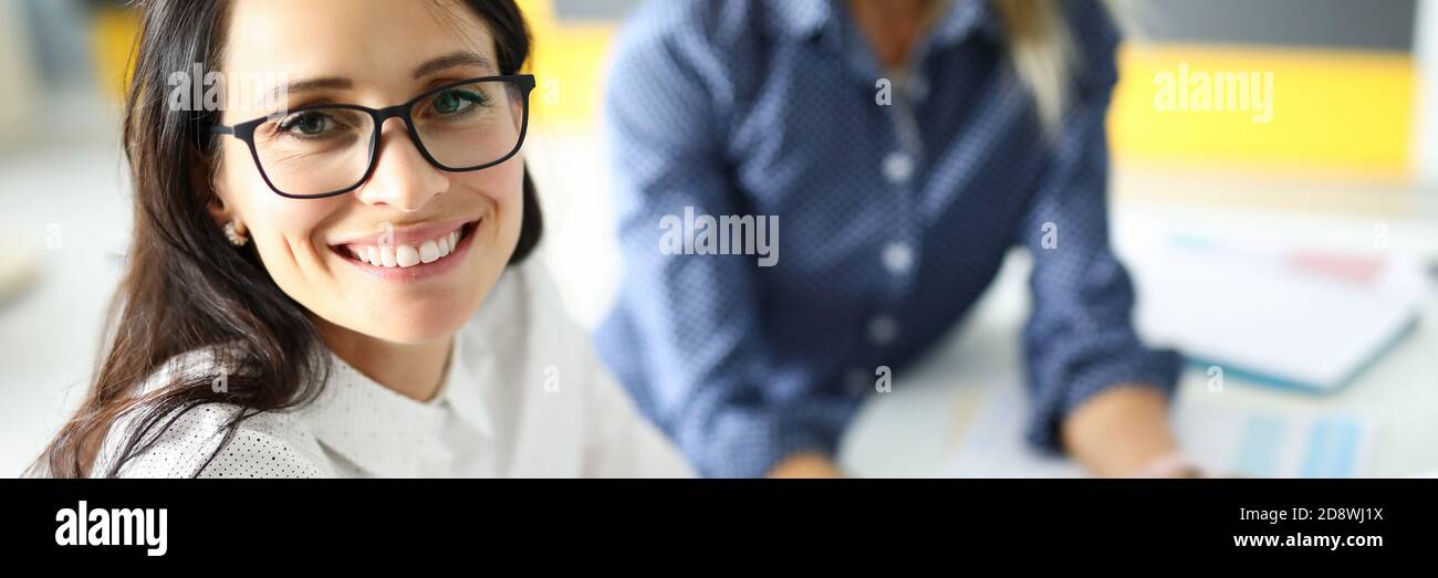 Smiling beautiful secretary in office Stock Photo - Alamy