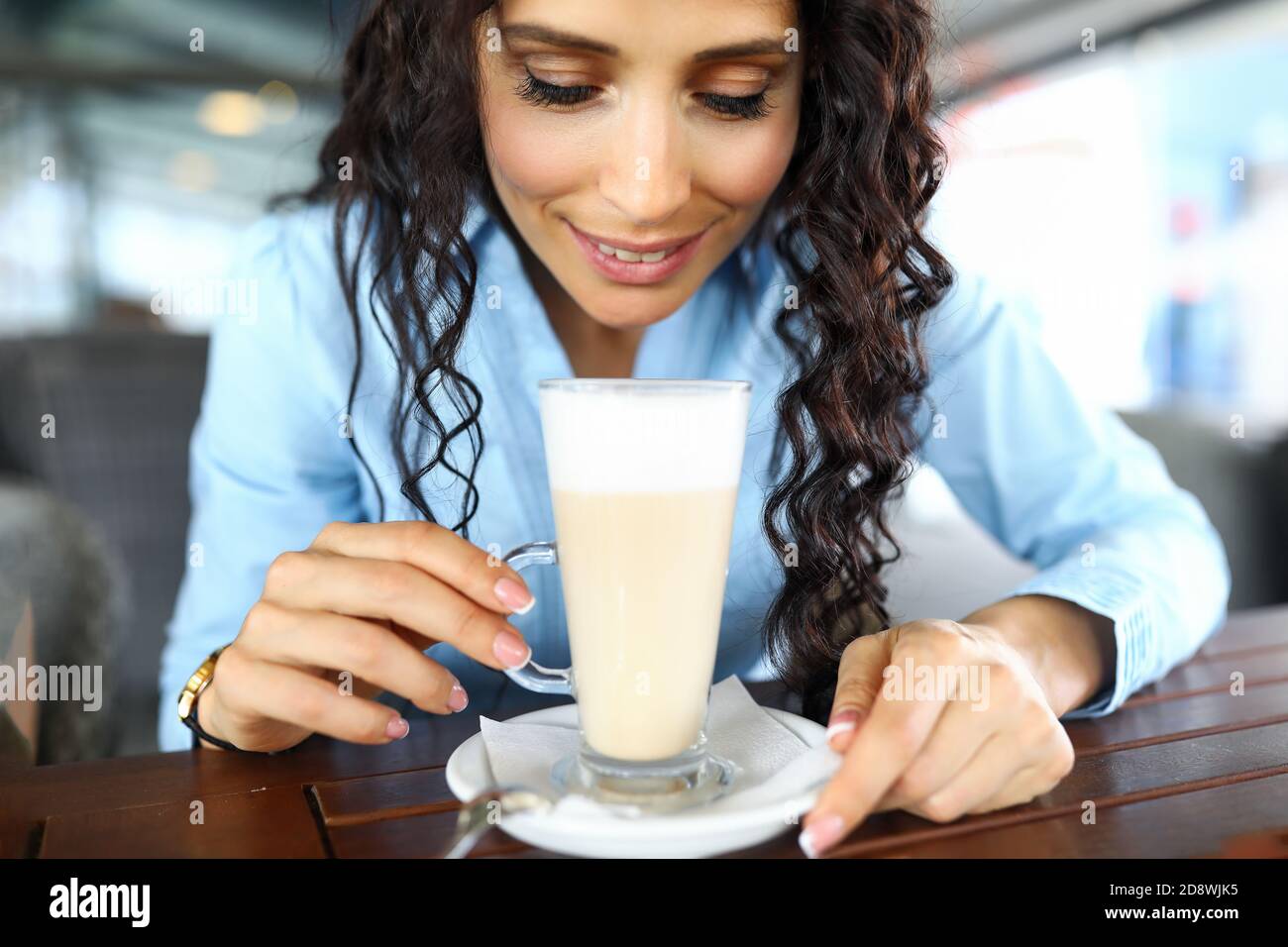 Female person drinking latte Stock Photo - Alamy