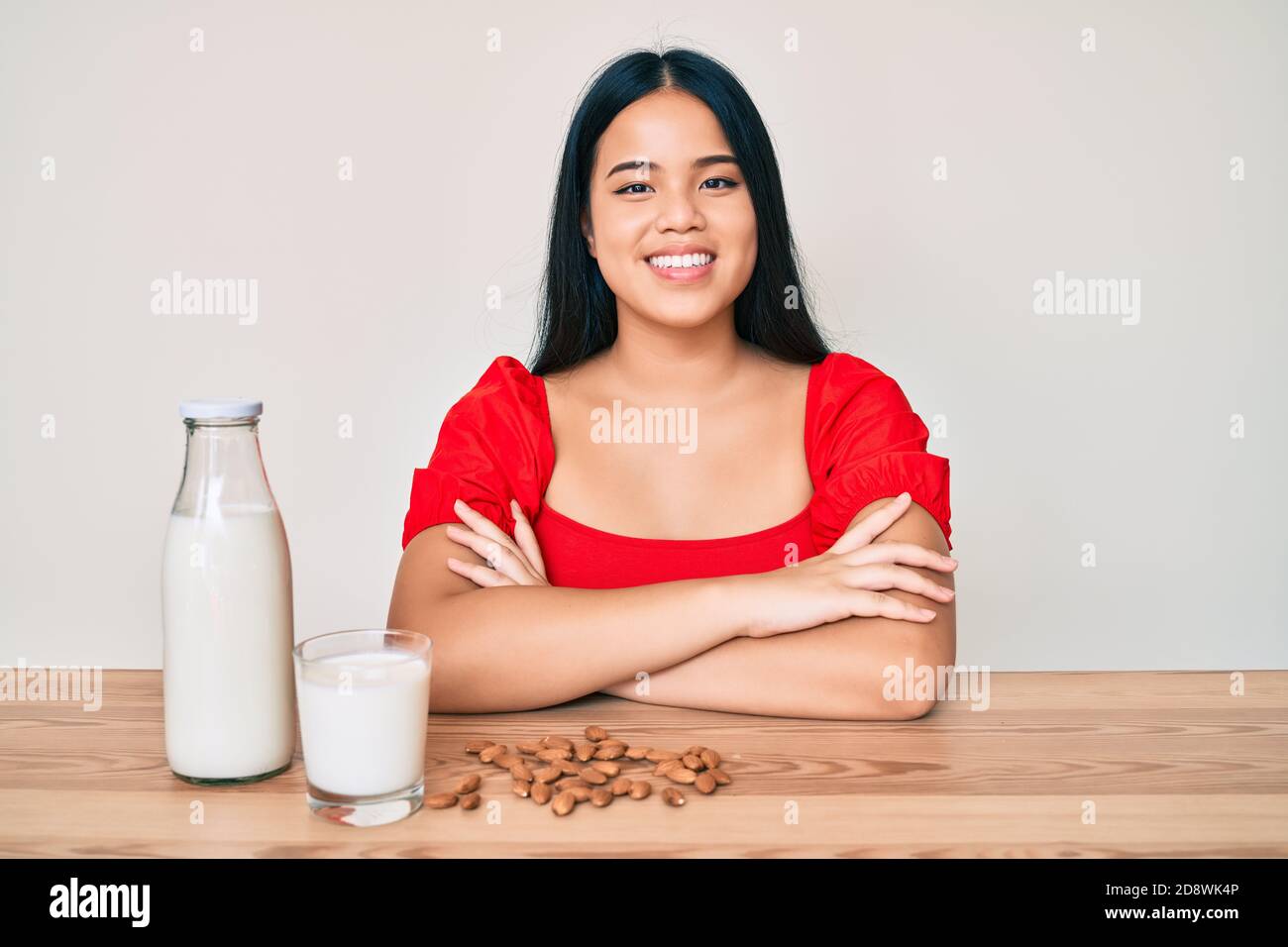 Young asian girl drinking healthy almond milk happy face smiling with ...