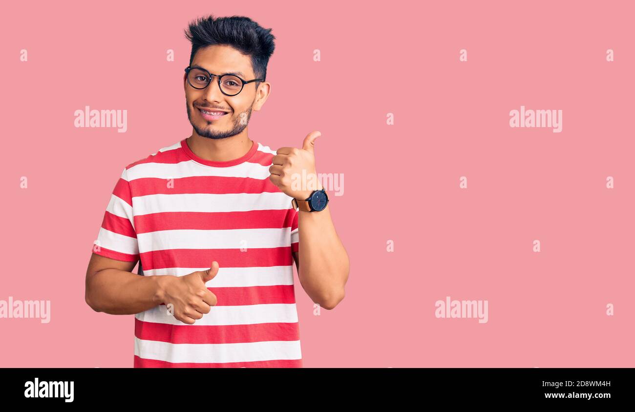 Handsome latin american young man wearing casual clothes and glasses ...