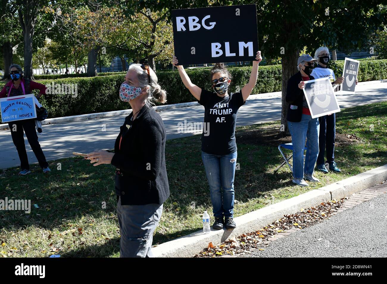 female protester with BLM sign and RBG during women's march Oct 17 2020 ...