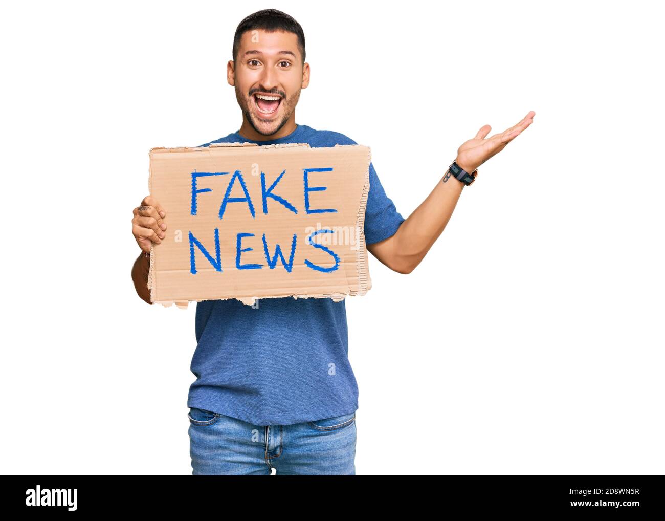 Handsome man with tattoos holding fake news banner celebrating victory ...