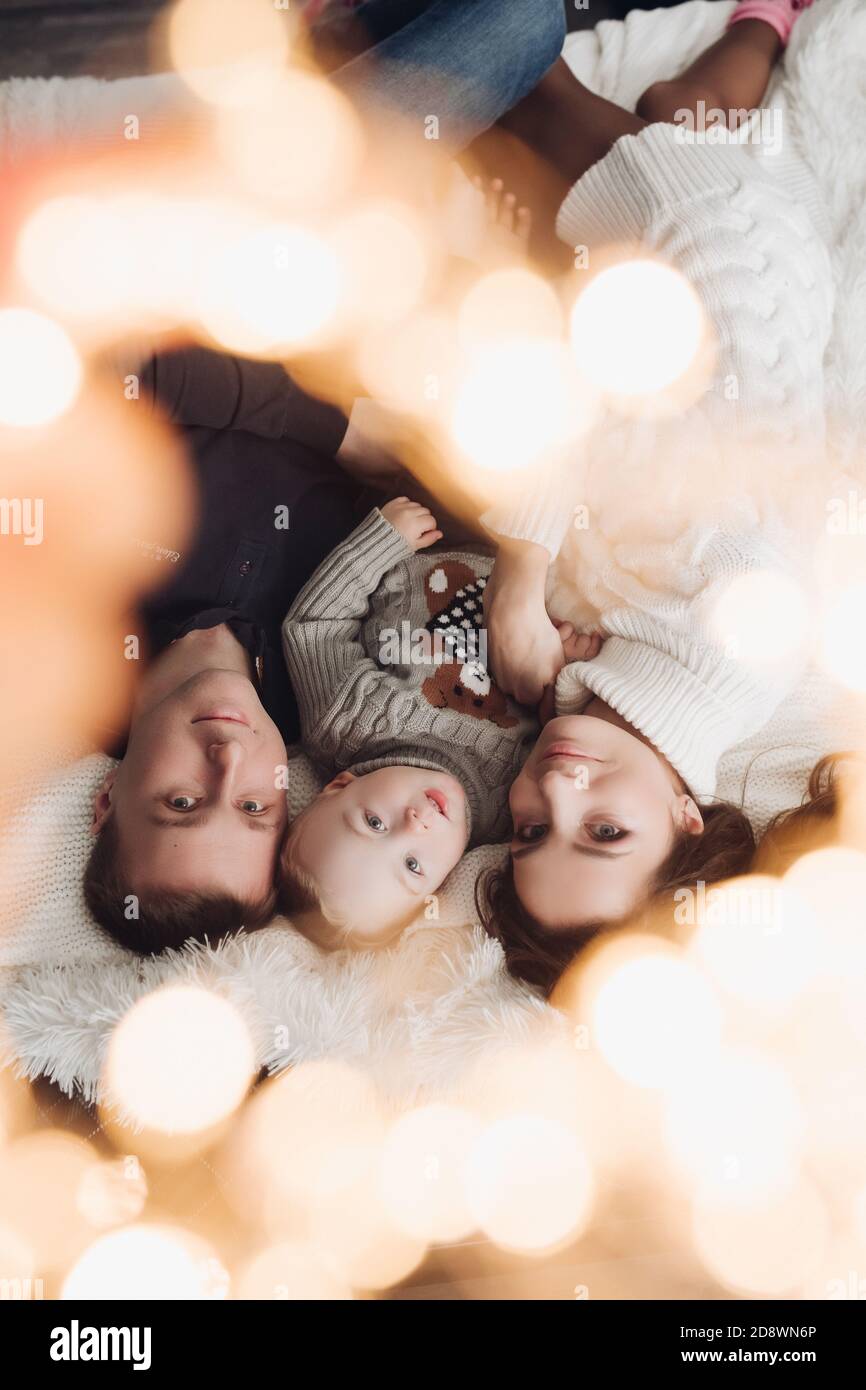 Loving parents and cute child cuddling together Stock Photo - Alamy