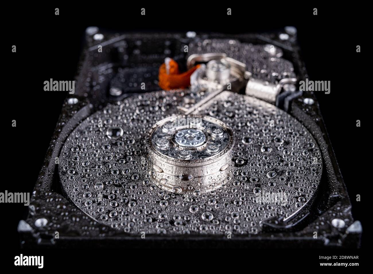 Wet old computer disk on the table. Head and computer data carrier ...