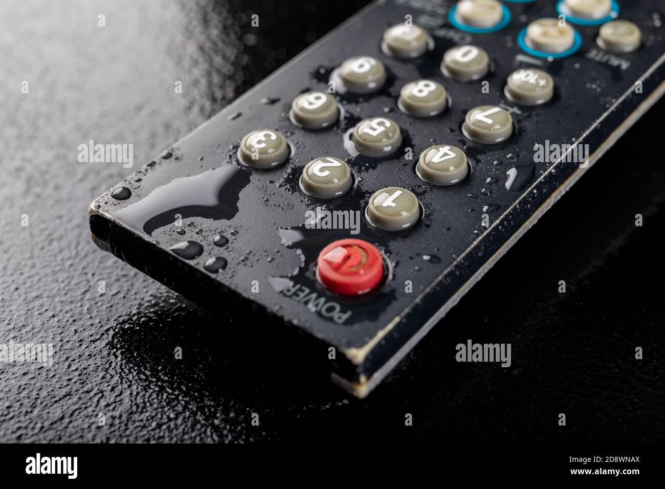 TV remote control with water drops. Water-poured electronic device ...