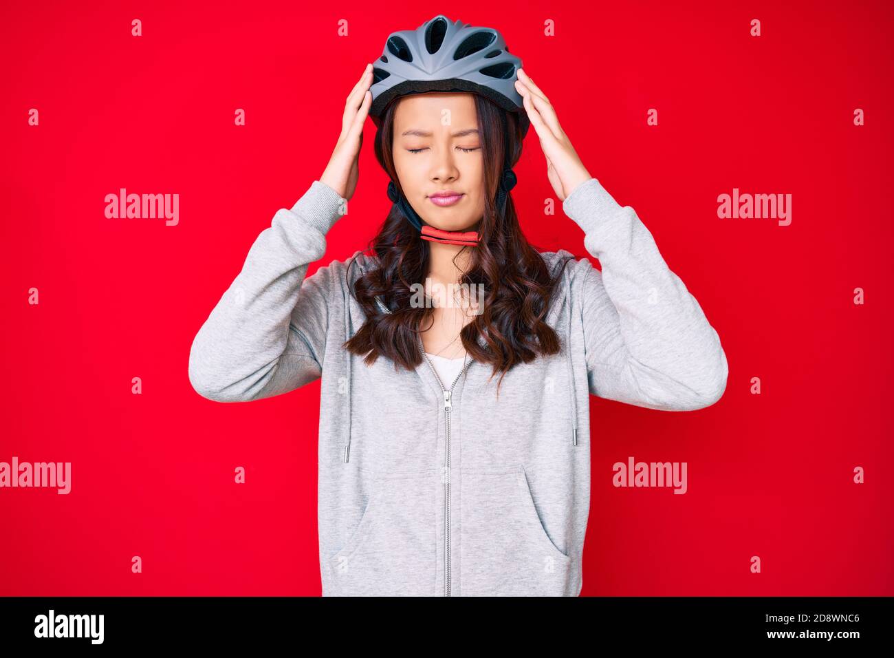 Young beautiful chinese girl wearing bike helmet suffering from ...