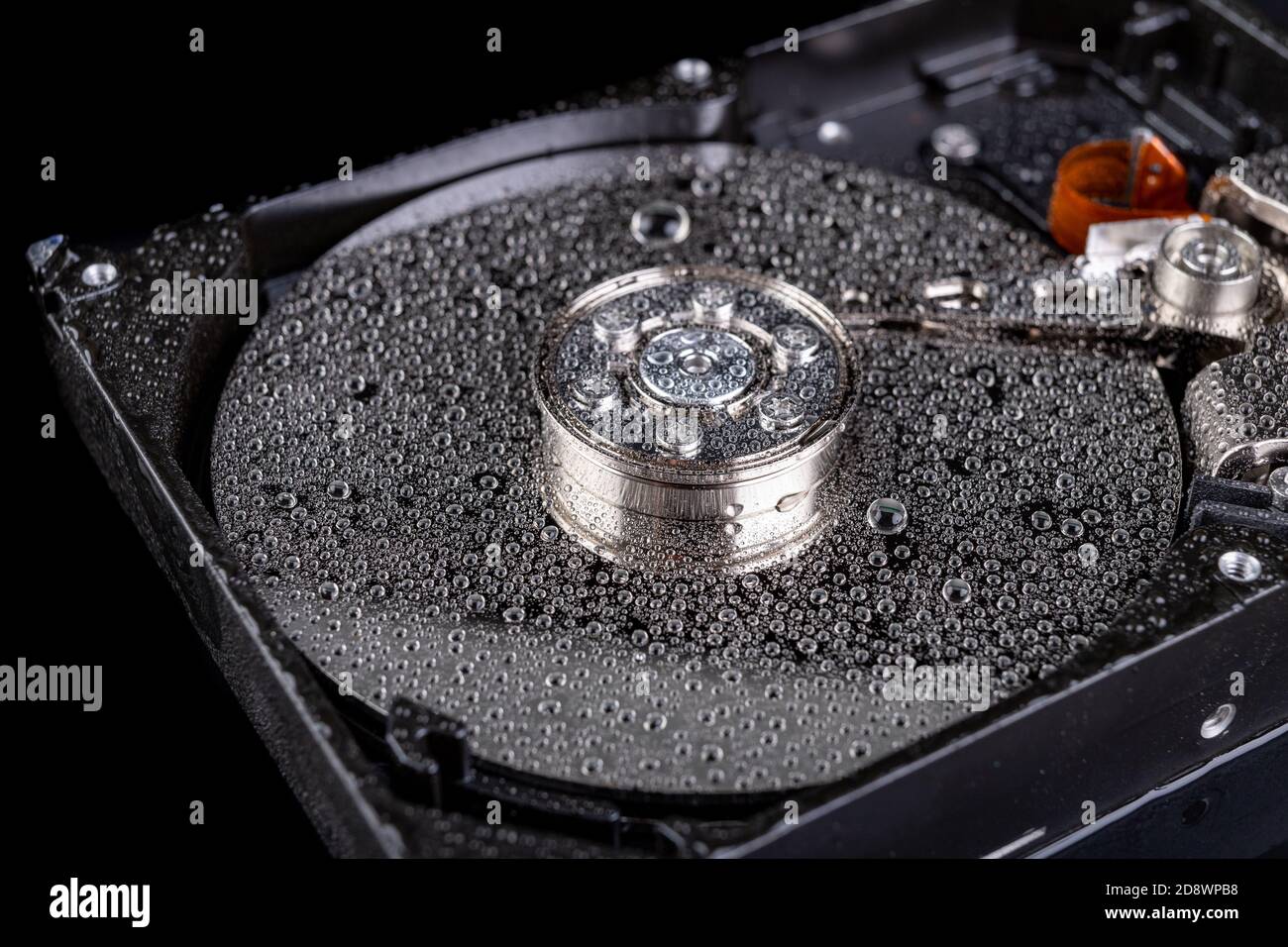 Wet old computer disk on the table. Head and computer data carrier ...