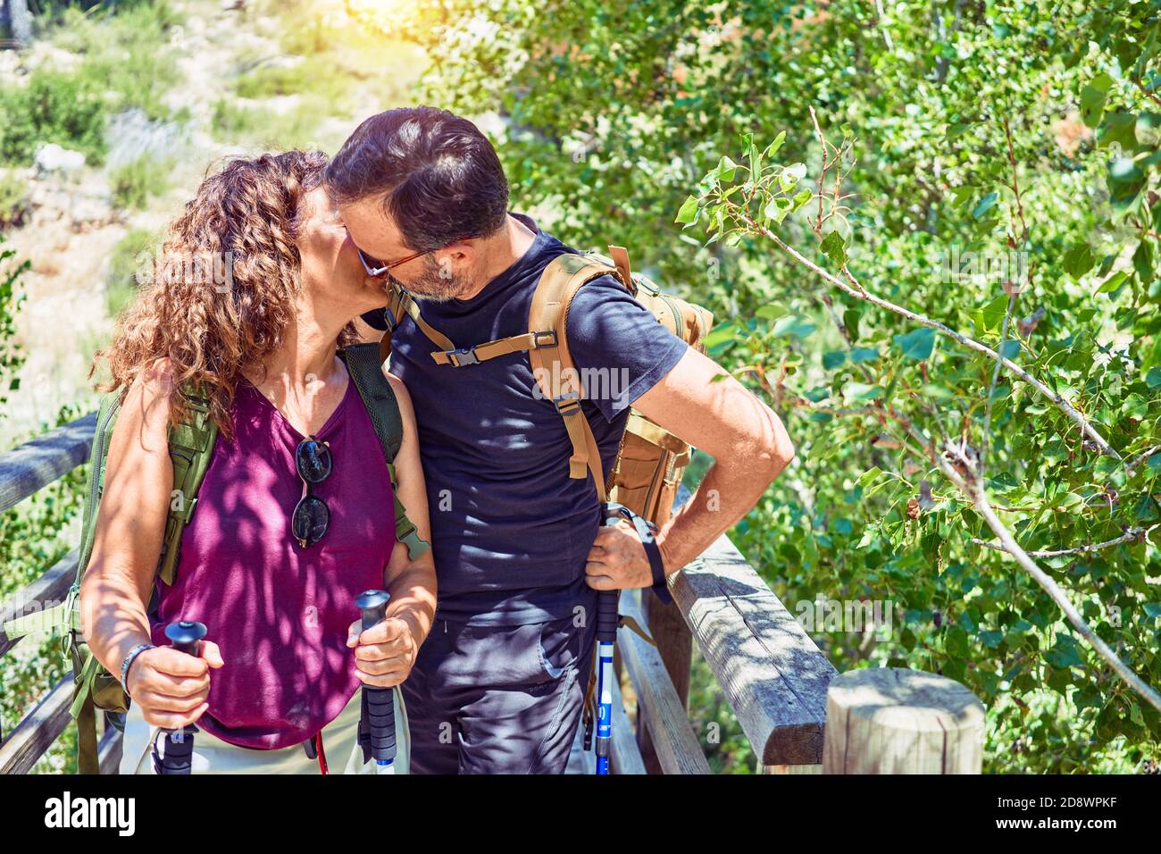 Beautiful couple of hiker wearing explorer clothes and backpack ...