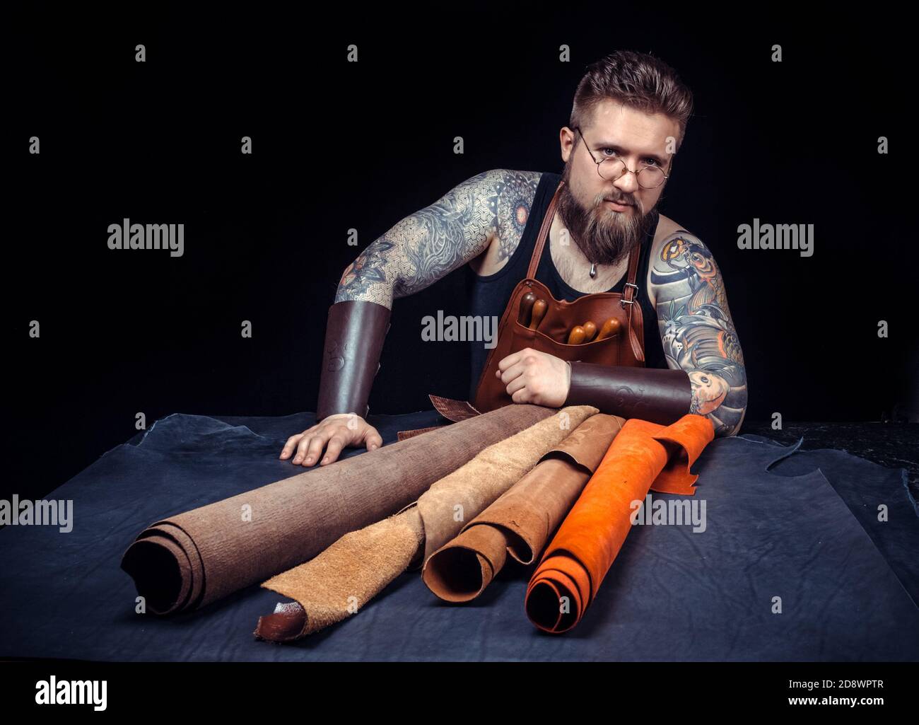 Leather cutter demostrating leather cutting process Stock Photo - Alamy