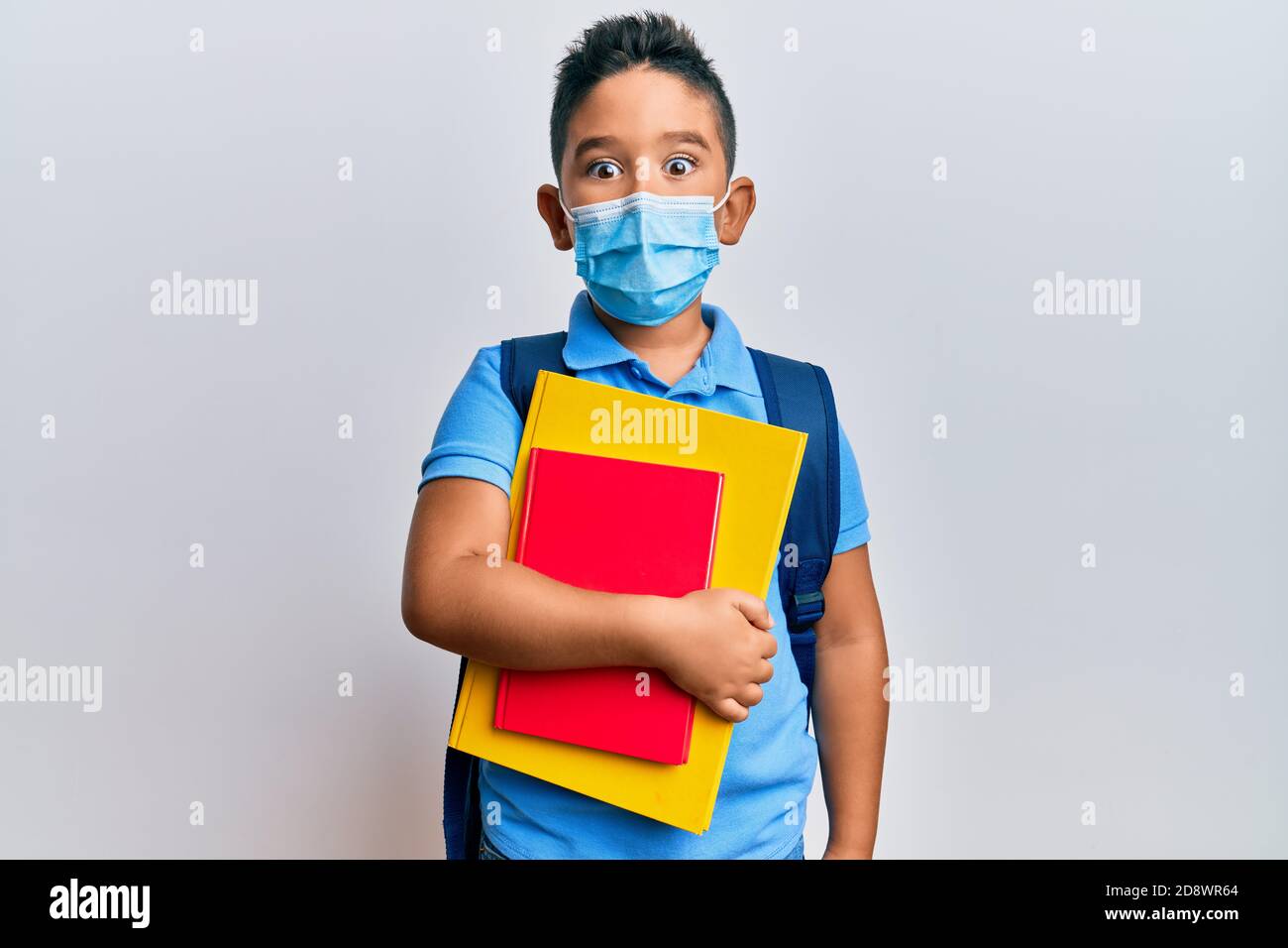 Little boy hispanic kid wearing medical mask going to school scared and ...