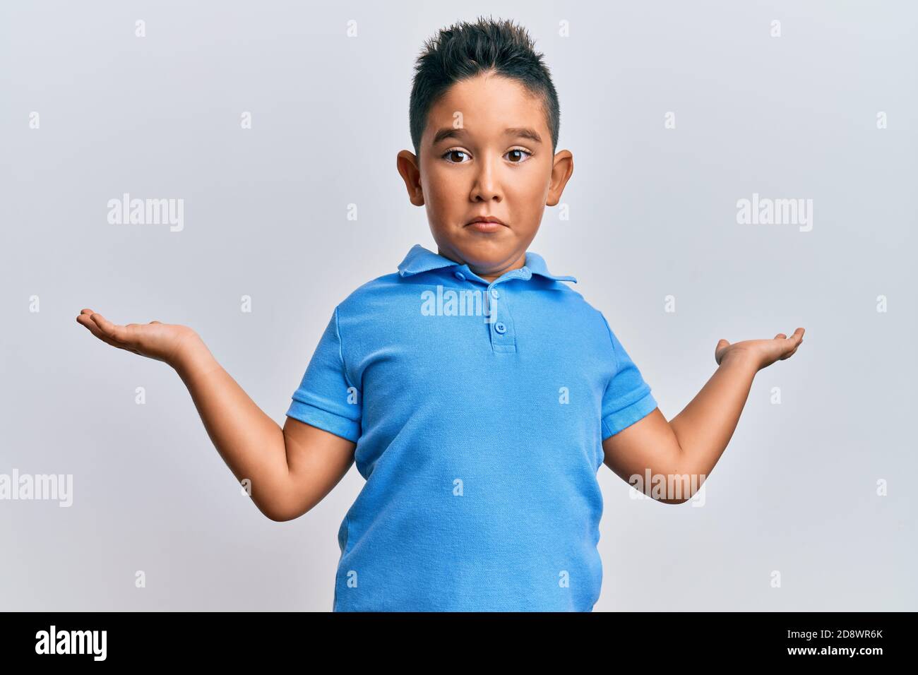Little boy hispanic kid wearing casual clothes clueless and confused ...