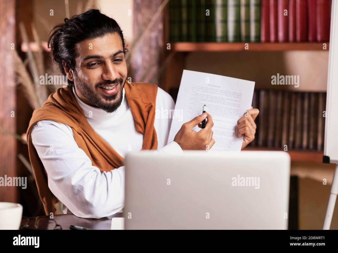 Indian Teacher At Laptop Having Class Teaching Online Sitting Indoors ...