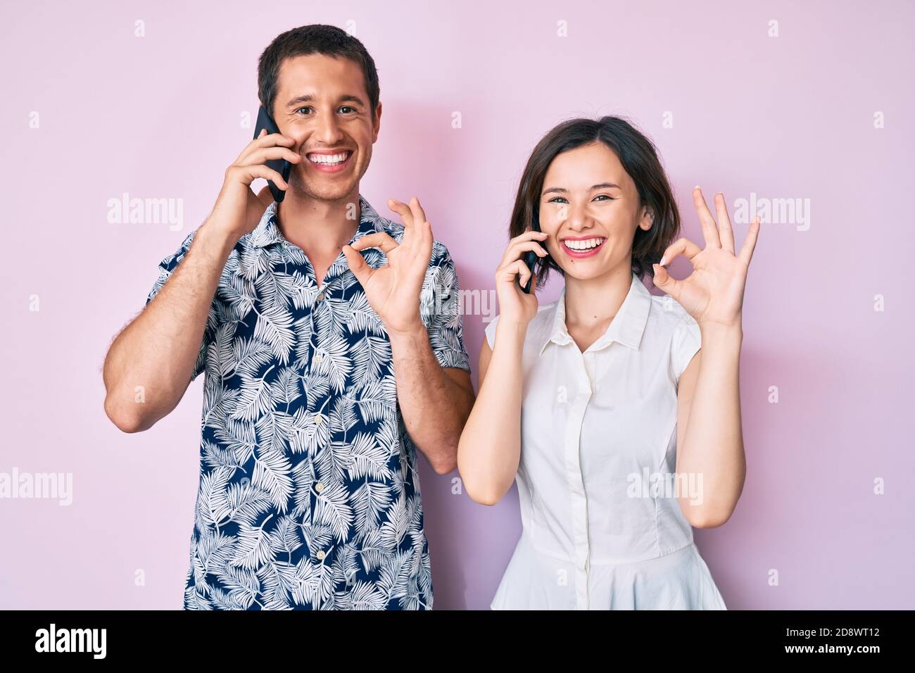 Beautiful couple having conversation talking on the smartphone doing ok ...