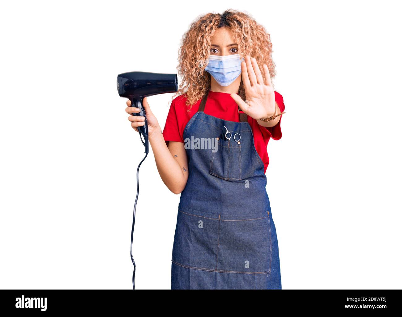 Young blonde woman with curly hair holding dryer blow wearing safety ...