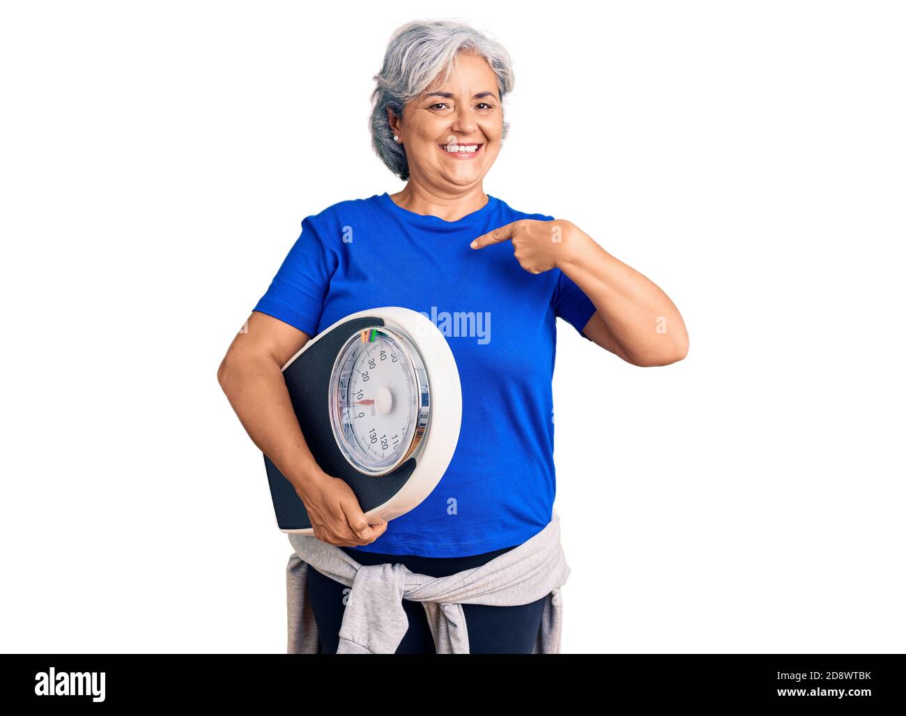 Senior woman with gray hair holding weight machine to balance weight ...