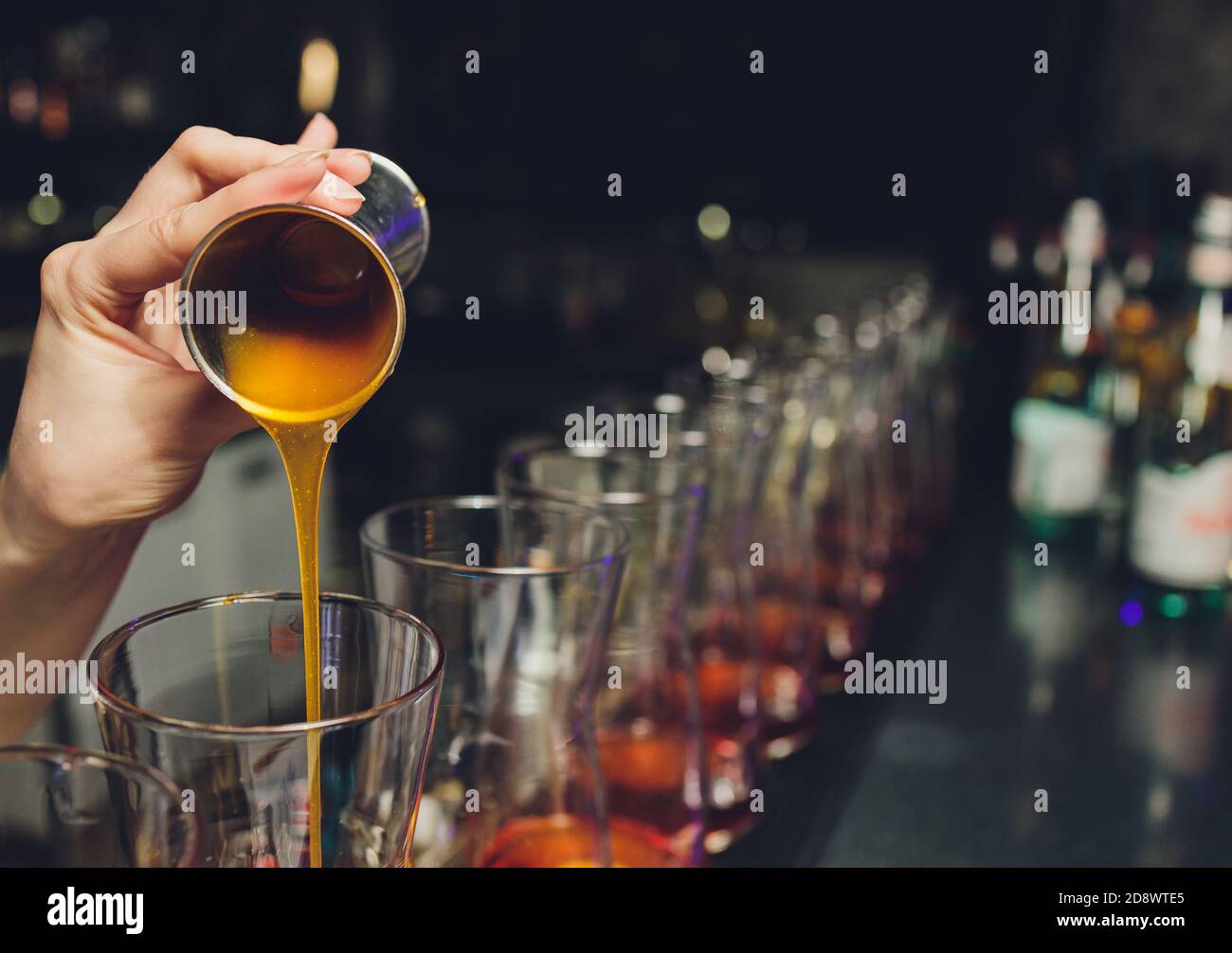 Bartender pours alcohol tall glass hi-res stock photography and images ...