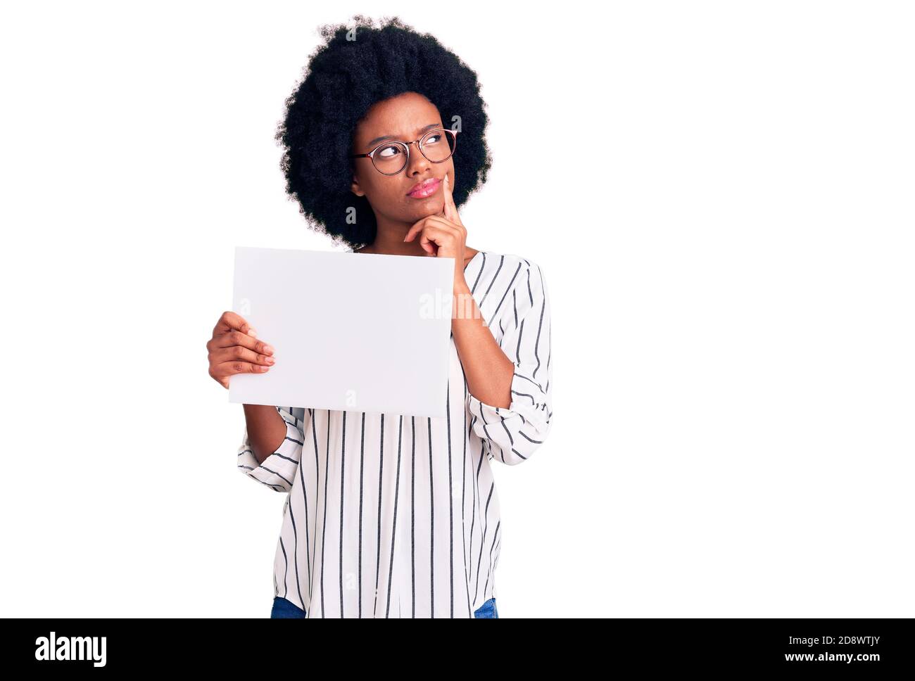 Young african american woman holding blank empty paper serious face ...